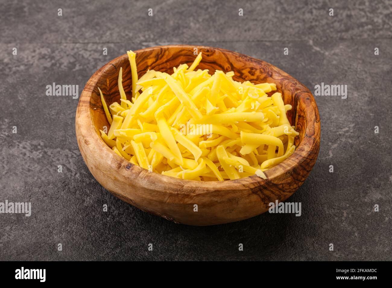 Shredded yellow cheese in the bowl for cooking Stock Photo - Alamy