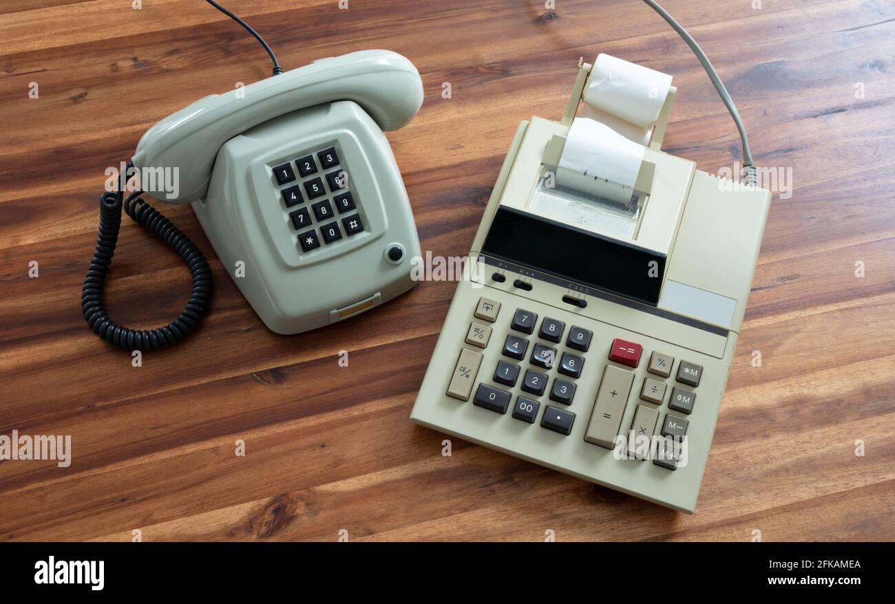 Old fashioned calculator and telephone on desk Stock Photo - Alamy