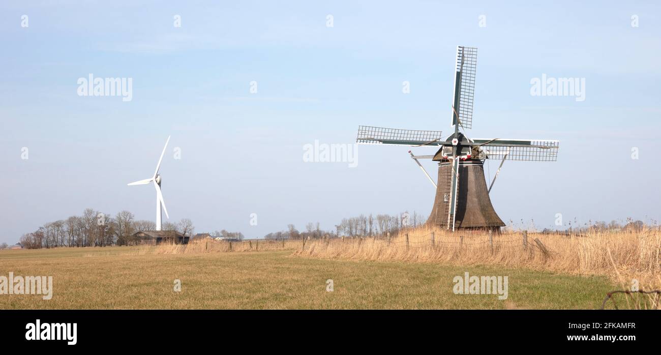 Old windmill and modern turbine in the Netherlands, catching dutch wind ...