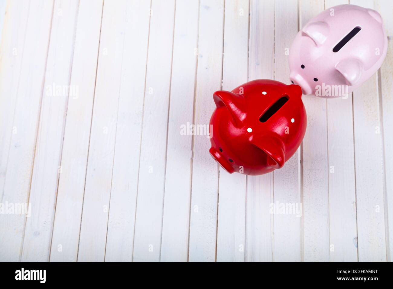 Two pigs piggy banks on a white wooden background, top view ...