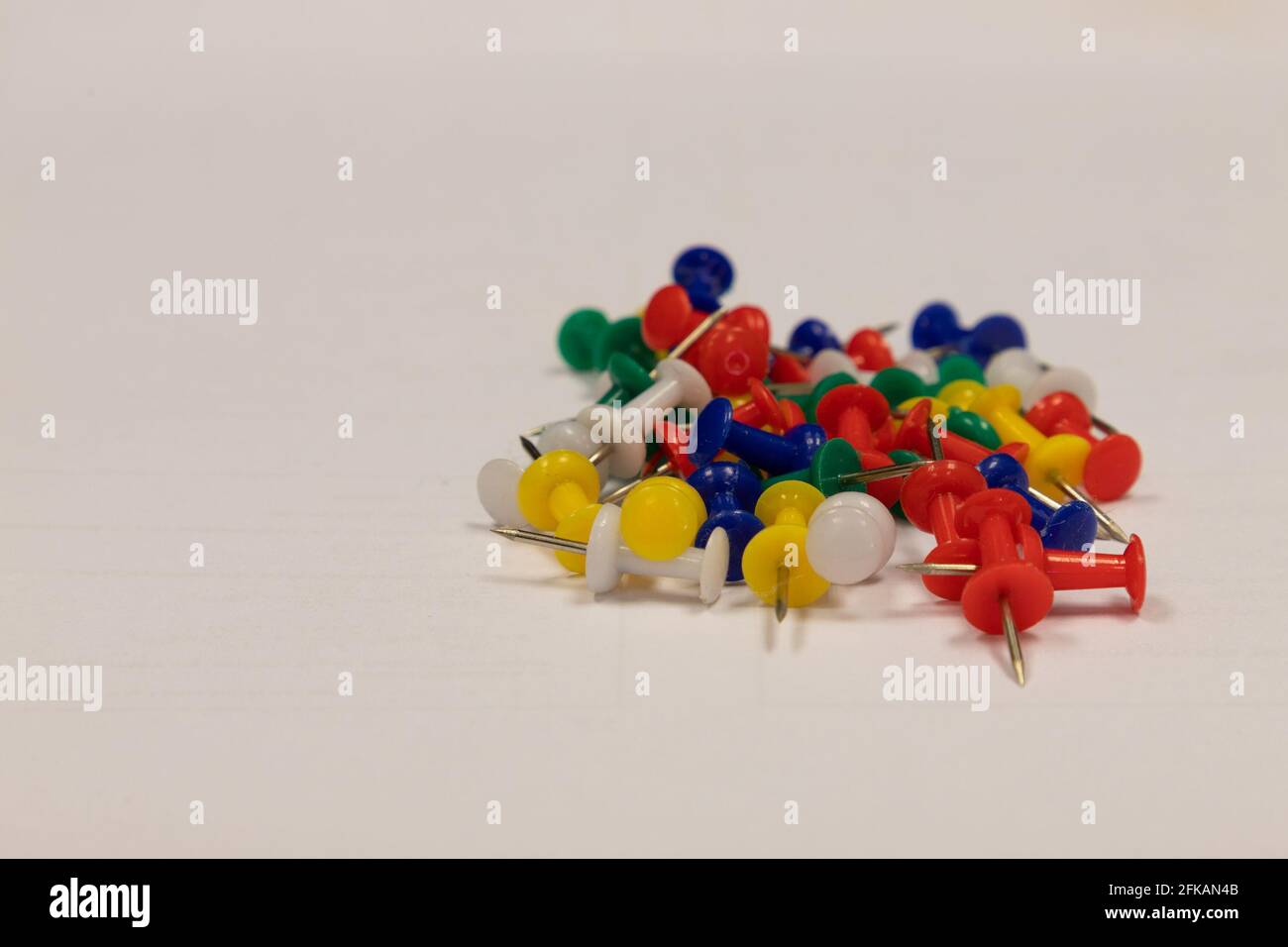 a pile of colorful push pins with white background Stock Photo - Alamy