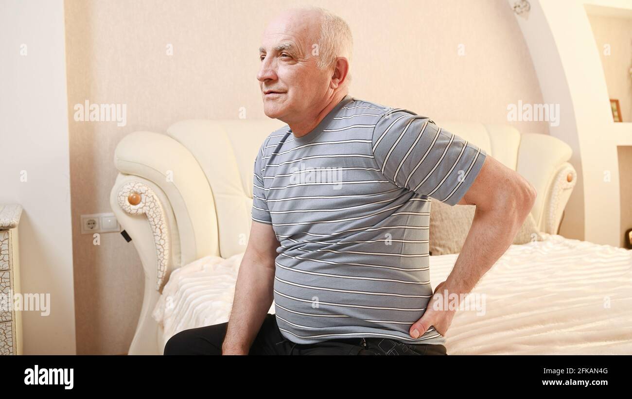 elderly man with back pain Stock Photo - Alamy
