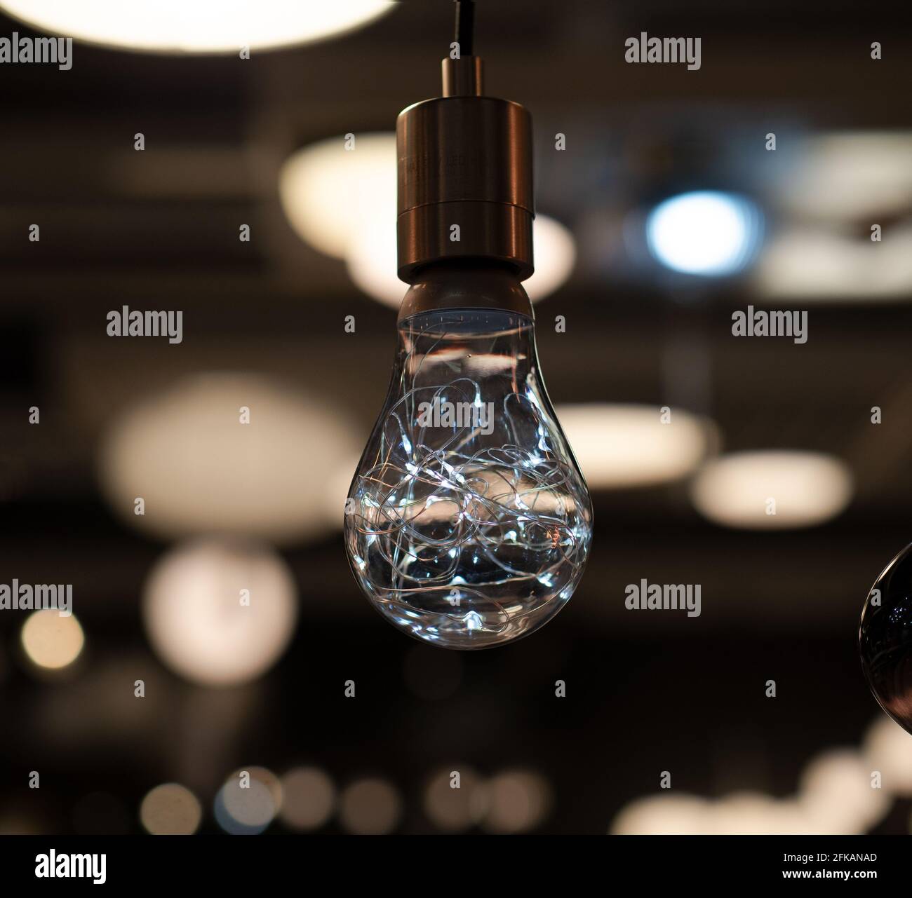 light bulb with led filaments shines in a dark room, background with ...