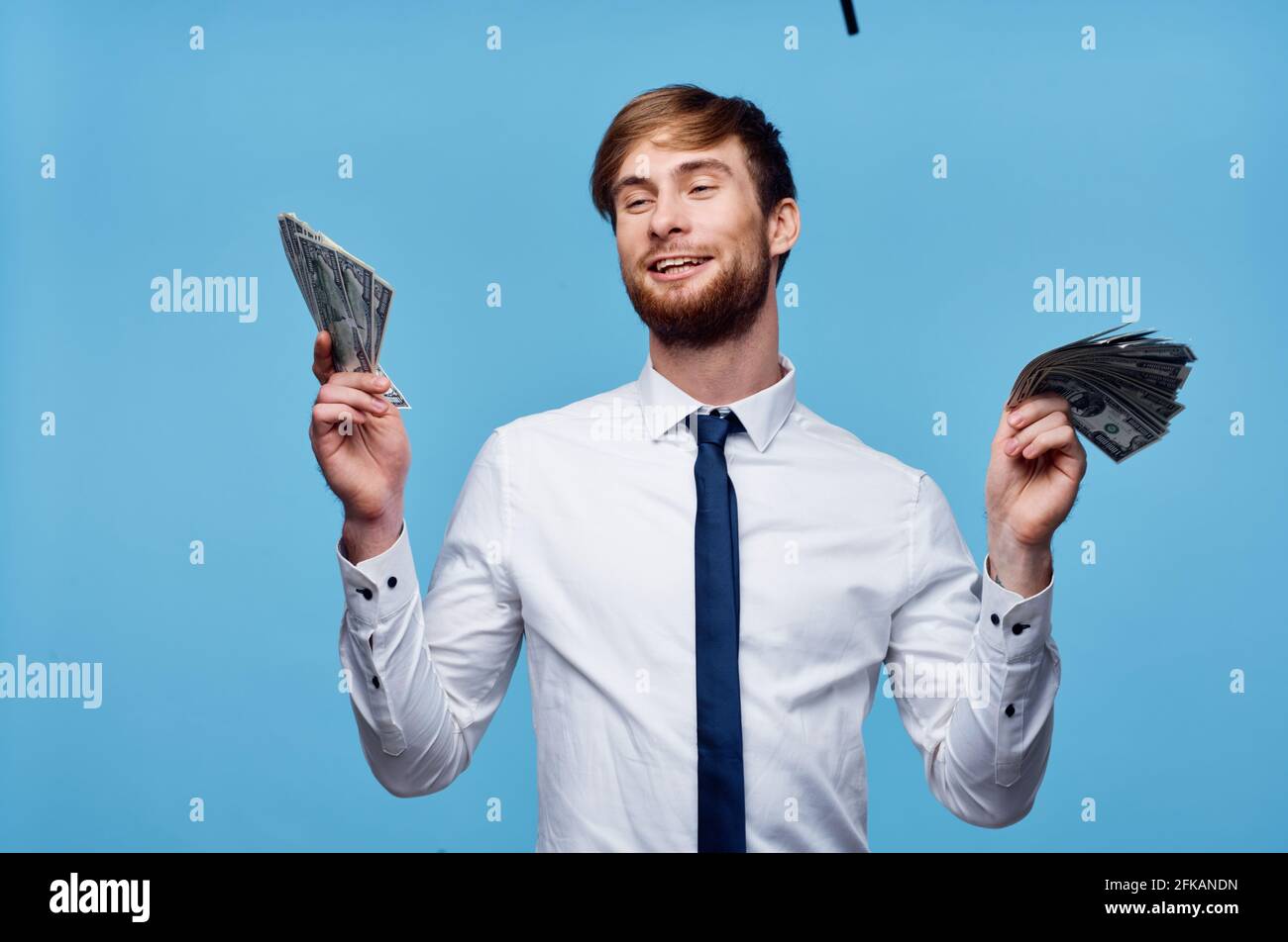 Cheerful man with wads of money in his hands success rich man Stock ...