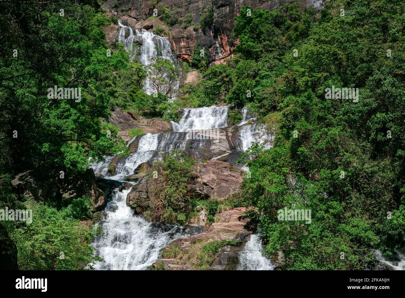 Beautiful Rawana Ella waterfall, surrounded by green tropical forest ...