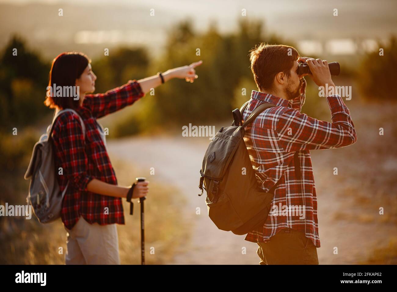 Portrait of happy young couple having fun on their hiking trip ...
