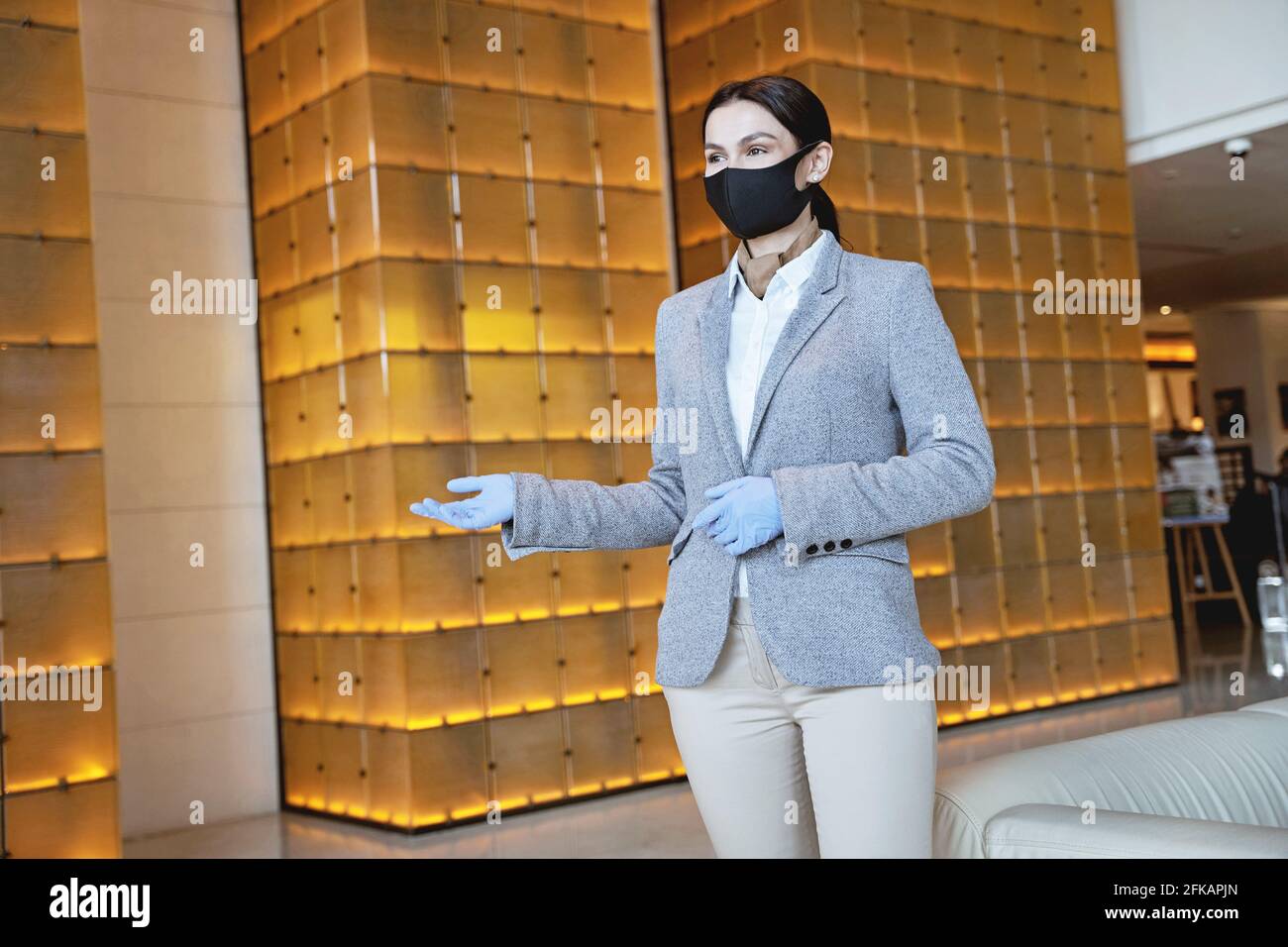 Friendly receptionist greeting the guests in the hall Stock Photo - Alamy