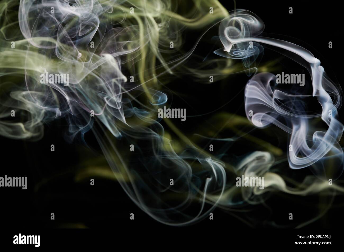 Yellow smoke abstract curves on black isolated background Stock Photo ...