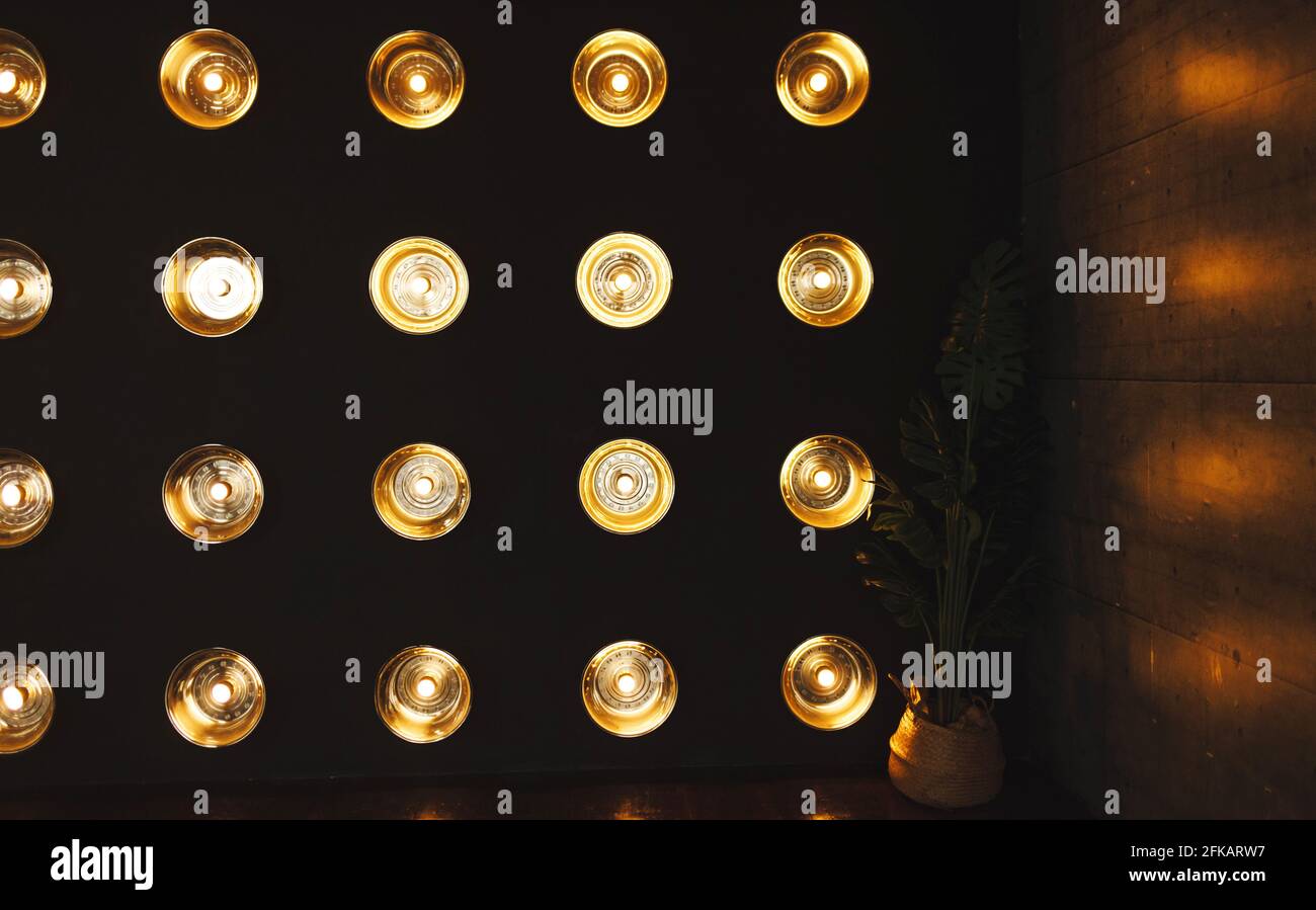 Loft interior design. Wall with built-in light bulbs Stock Photo - Alamy