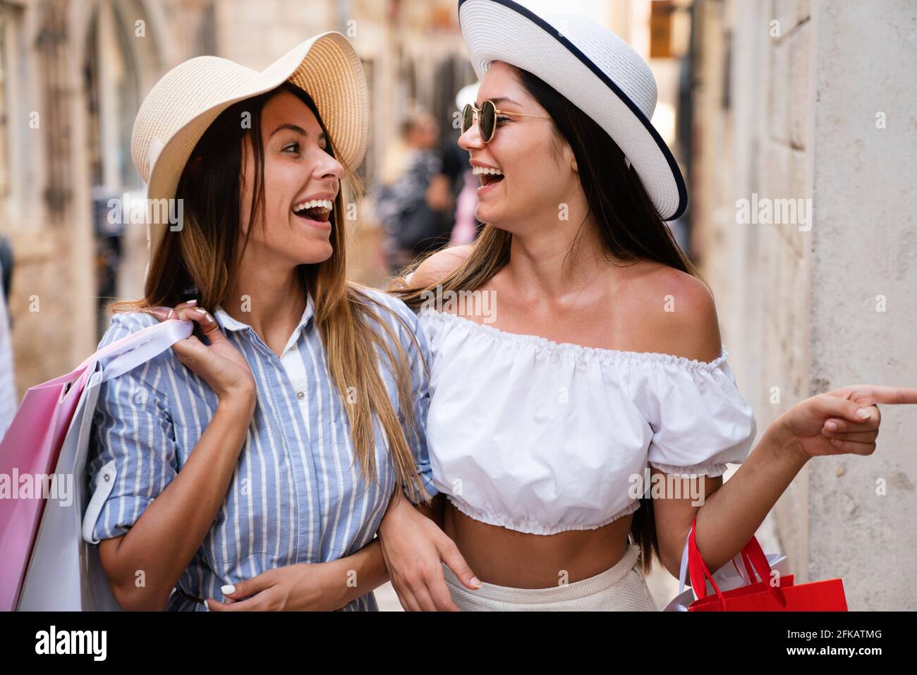 Sale, consumerism, shopping and people concept. Happy young women with ...