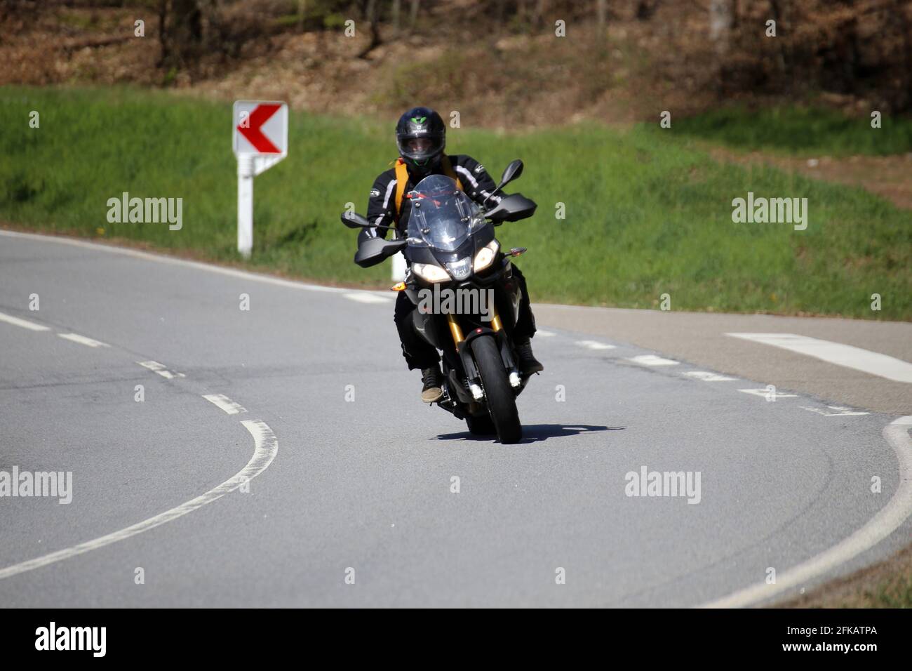 Cyclist on winding highway hi-res stock photography and images - Alamy