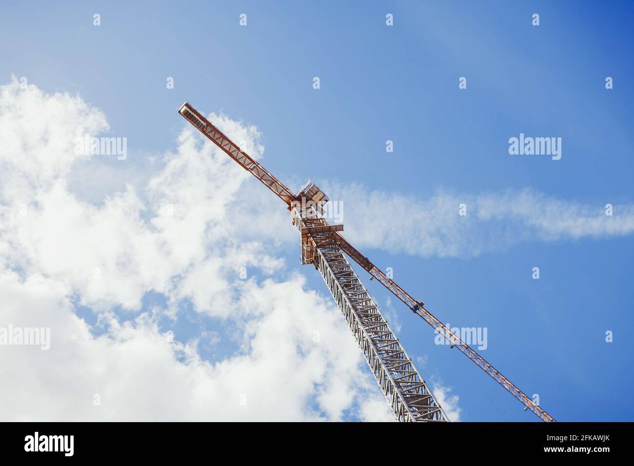 perspective view looking up tall construction crane on a building site ...
