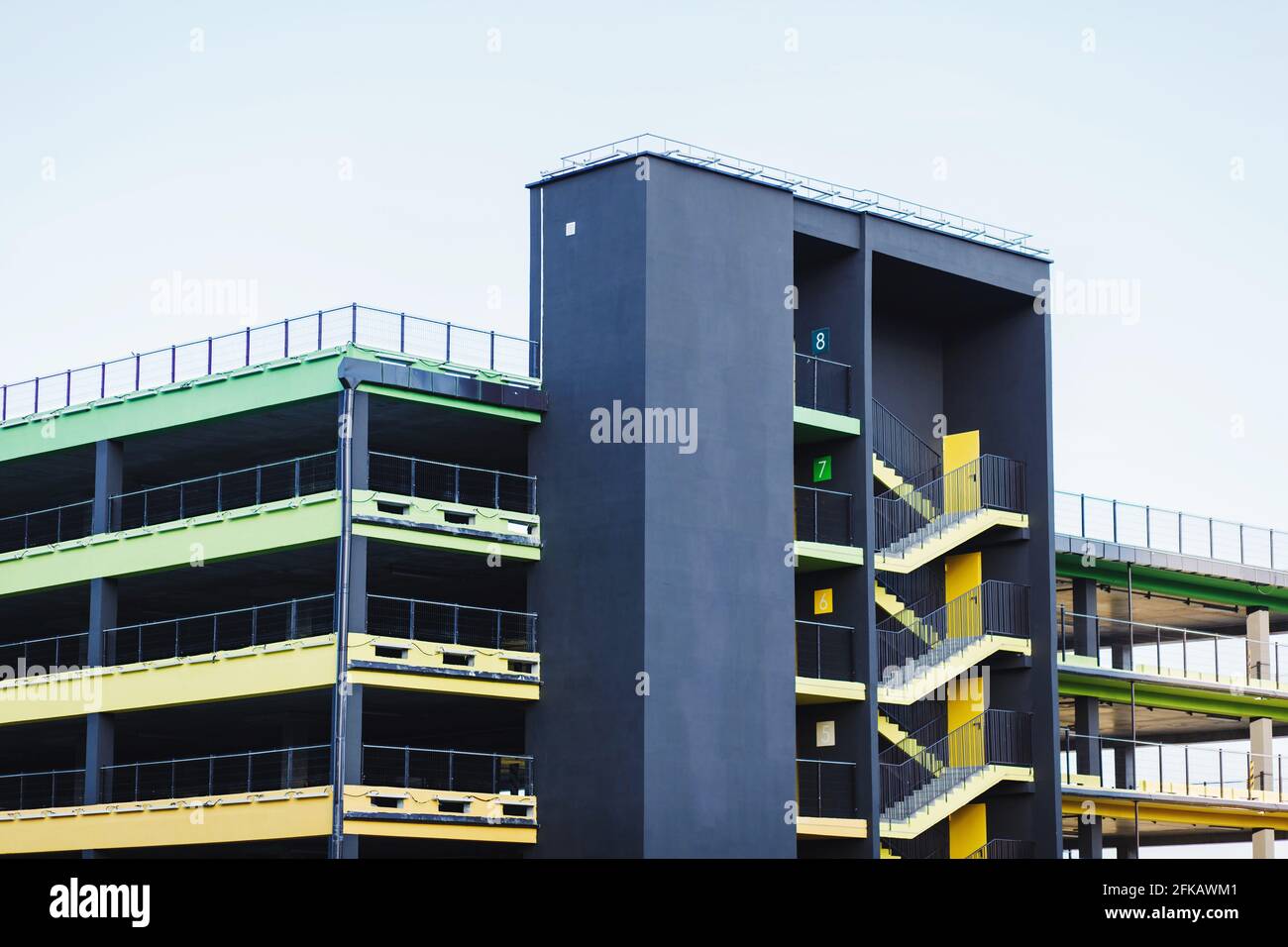 stair on the side of a colorful multi storey parking lots building ...