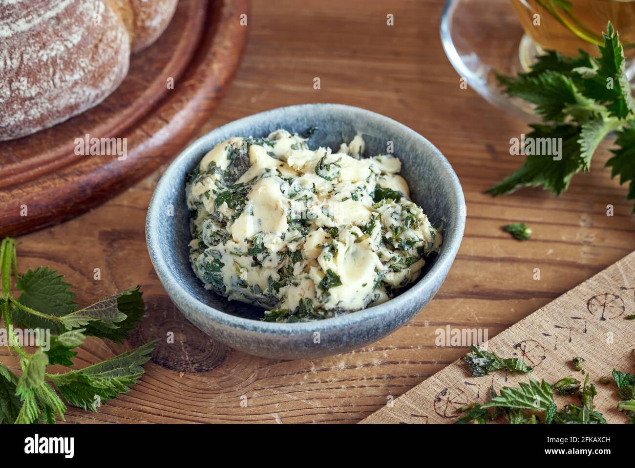 Homemade bread spread made from butter and young nettles collected in ...