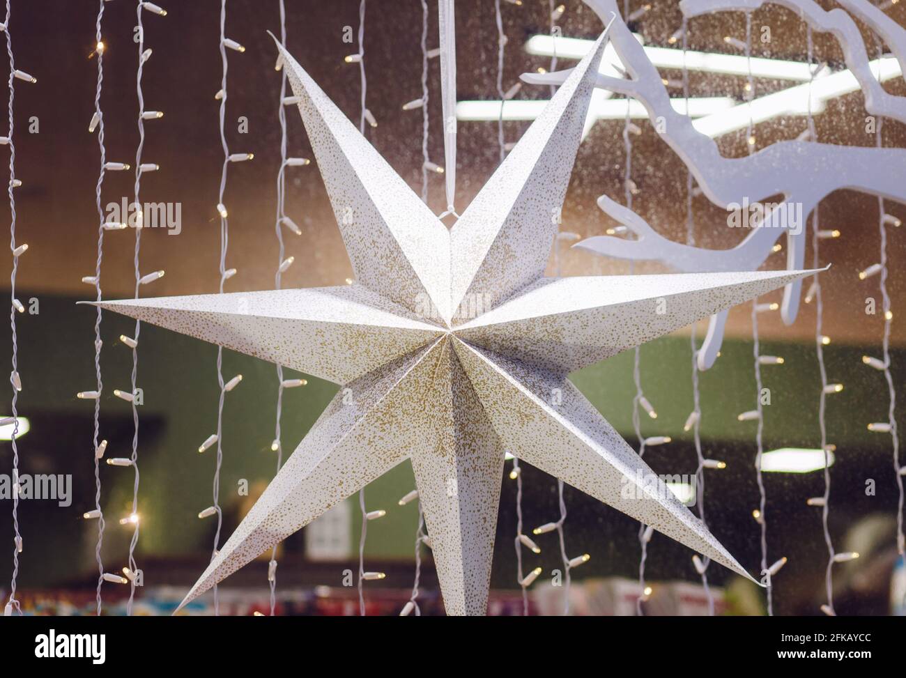 large Christmas star hangs in a shop window Stock Photo - Alamy