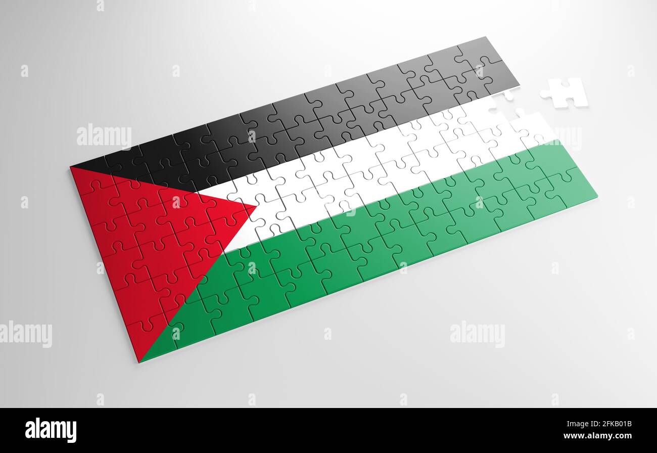 A jigsaw puzzle with a print of the flag of Palestine, pieces of the ...