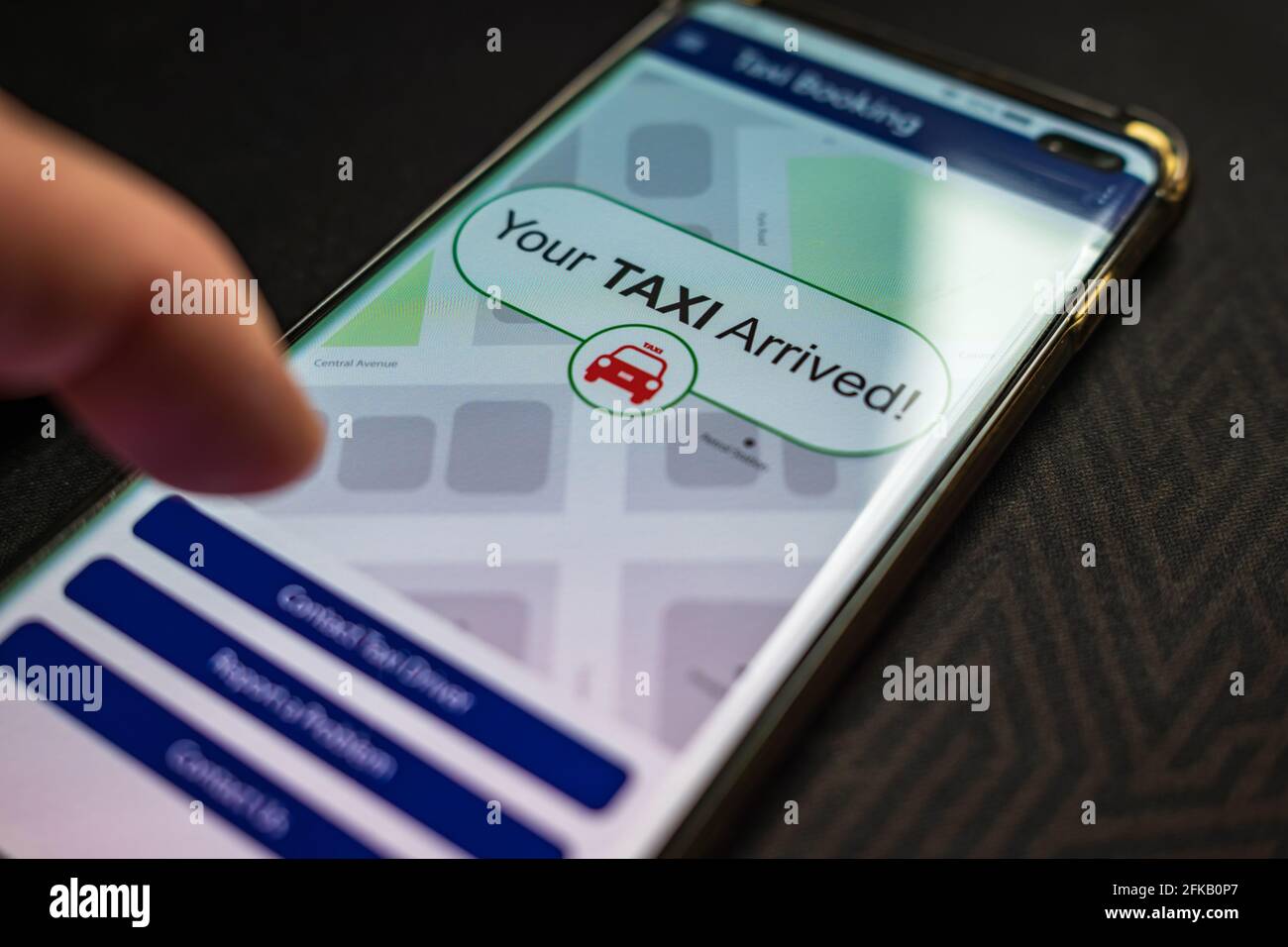 Male thumb finger over taxi arrived message smartphone screen app Stock ...