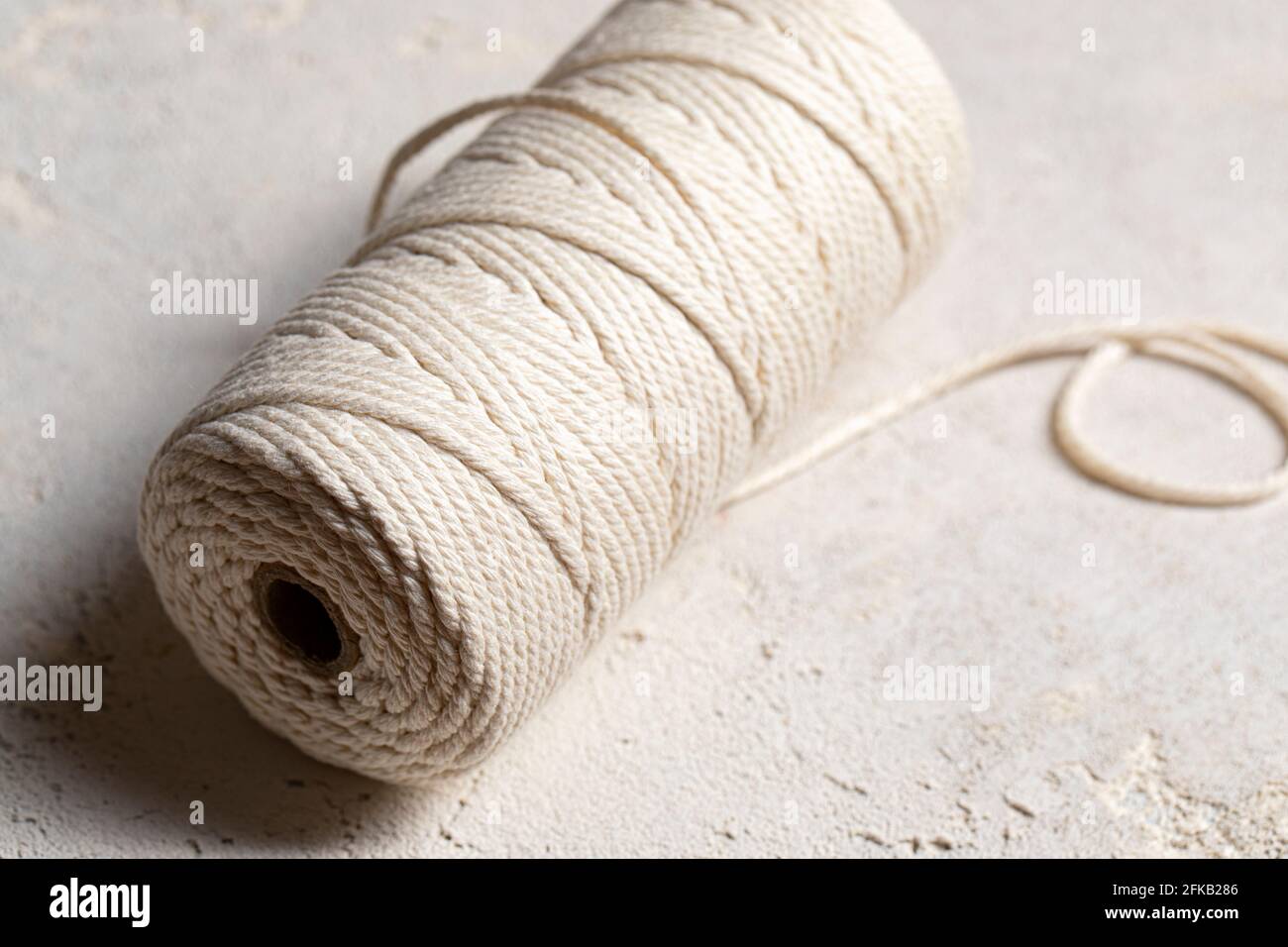 Macrame cotton spool on white concrete background, top view Stock Photo ...