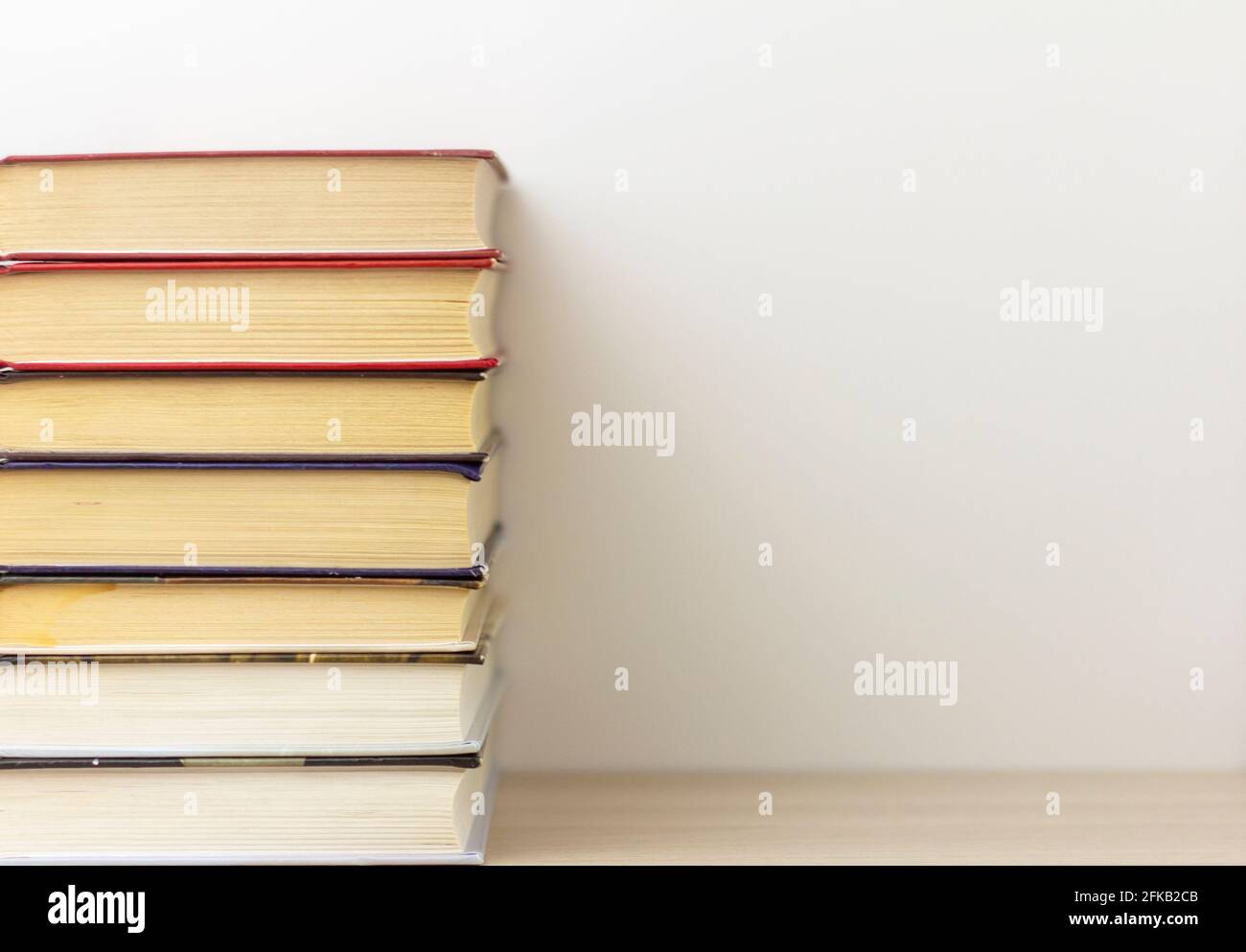 Books.A stack of neatly stacked books on a table or shelf with a copy ...