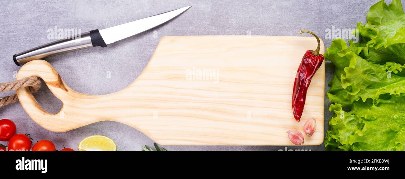 Cutting board on the table. Handmade chopping board. Fresh vegetables ...