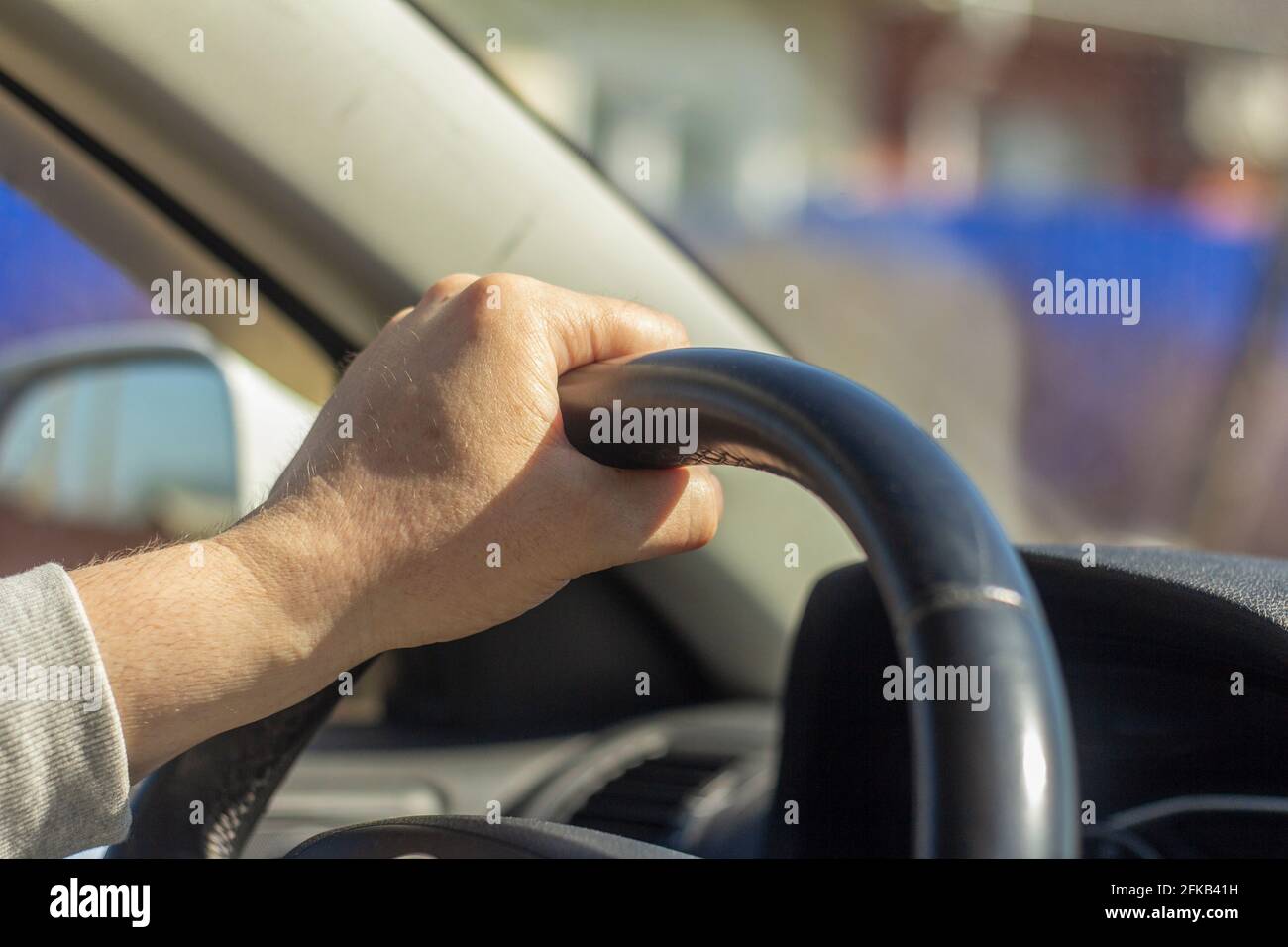 Mans hand steering wheel hi-res stock photography and images - Alamy
