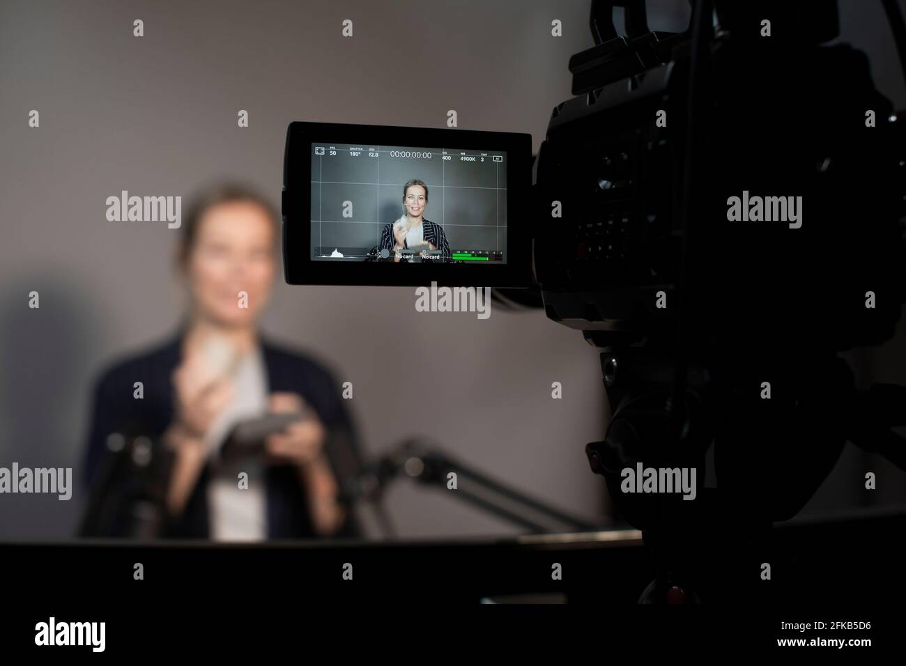 Female entrepreneur recording video on camera at office Stock Photo - Alamy