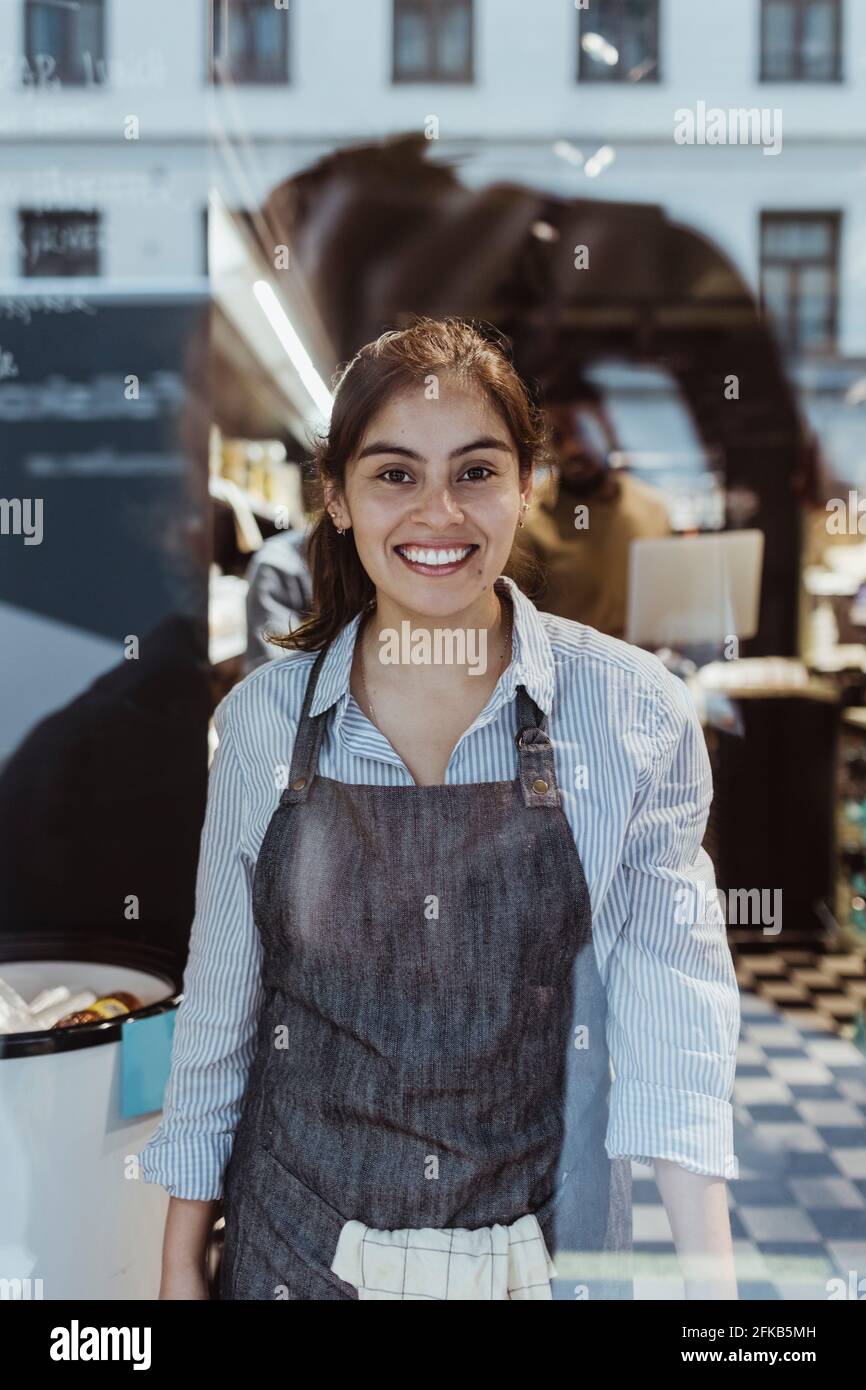 Portrait of smiling female owner at deli store Stock Photo - Alamy
