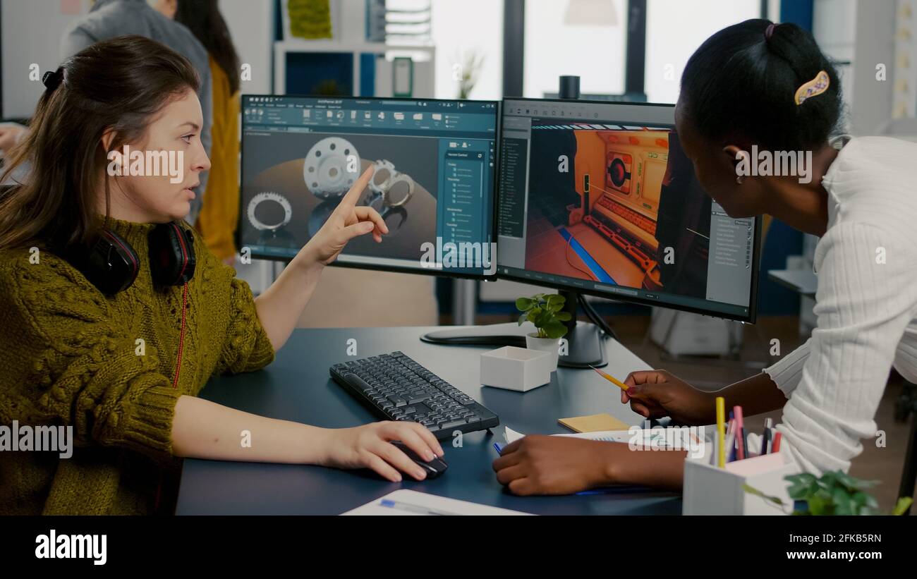 Gamer creator explaning to african worker how testing game level ...