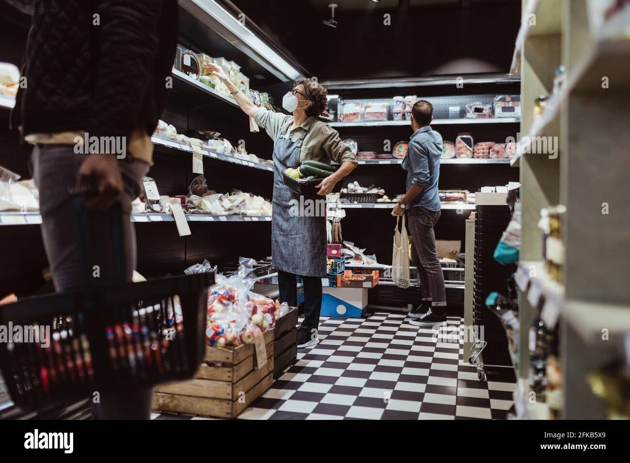 Male customers collecting package product while female owner standing ...