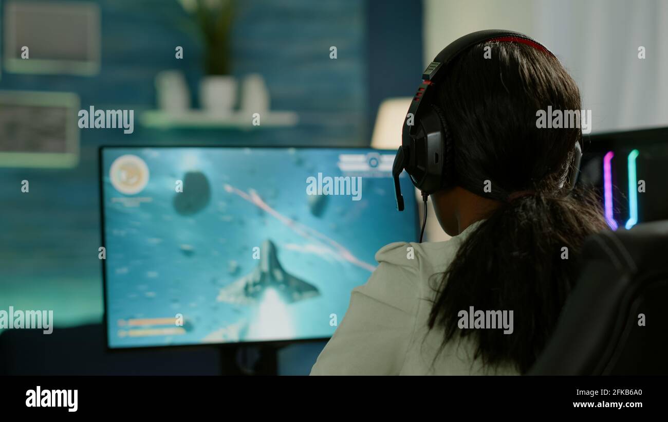 Closeup of competitive black woman player holding joystick playing ...