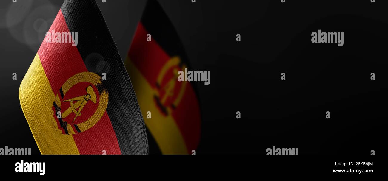 Small national flags of the GDR on a dark background Stock Photo - Alamy