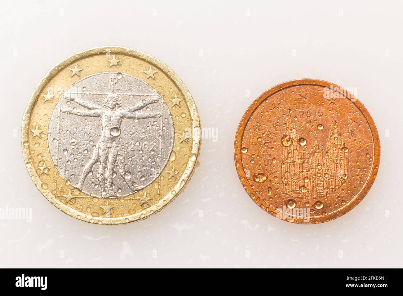 Euro coins, euros and euro cents on white background. Coins with water ...