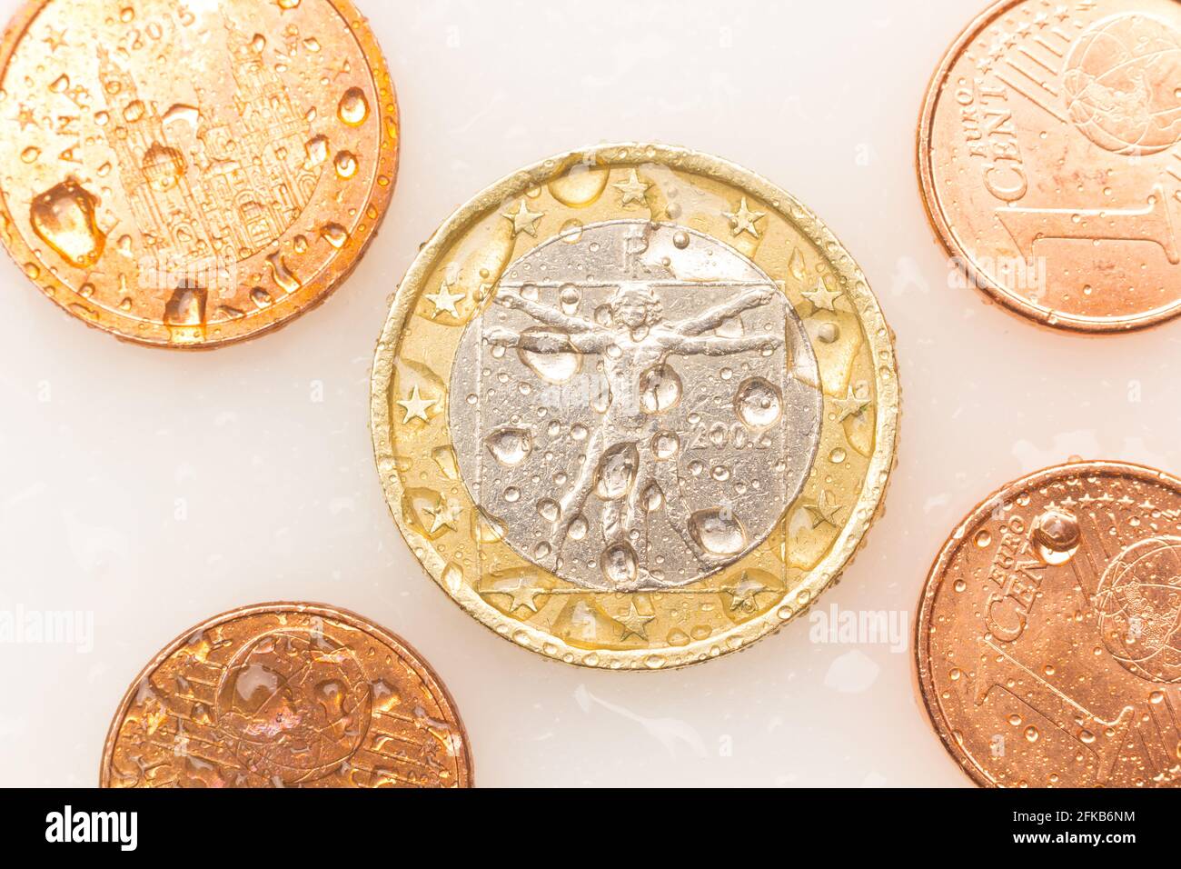 Euro coins, euros and euro cents on white background. Coins with water ...