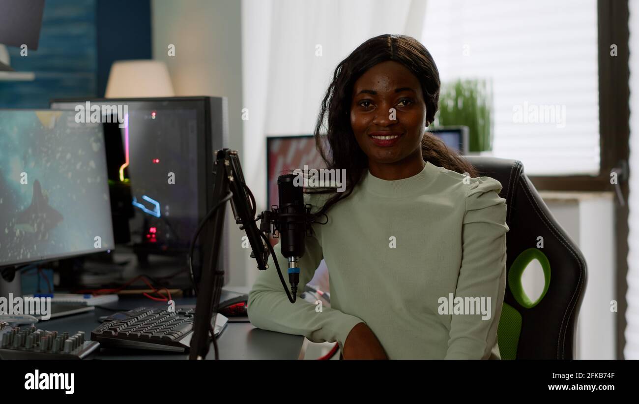 Portrait of excited african professional streamer player looking at ...