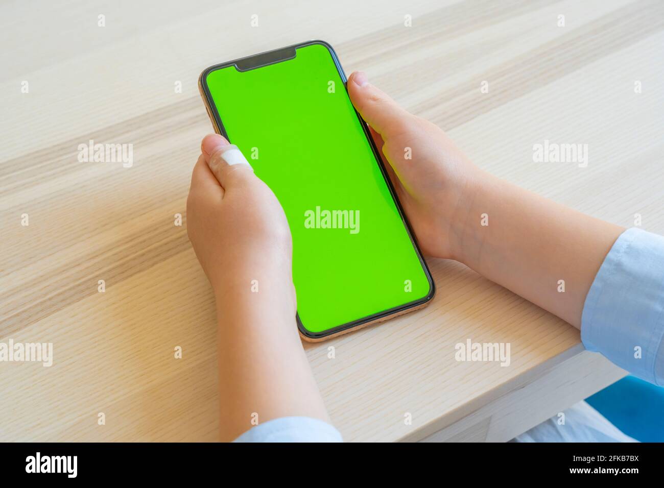 Girl using mobil phone with green screen Chroma key. Close-up shot of ...