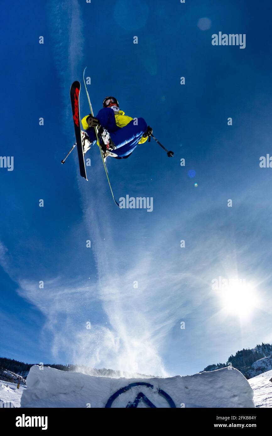 A man flying through the air while riding skis Stock Photo - Alamy