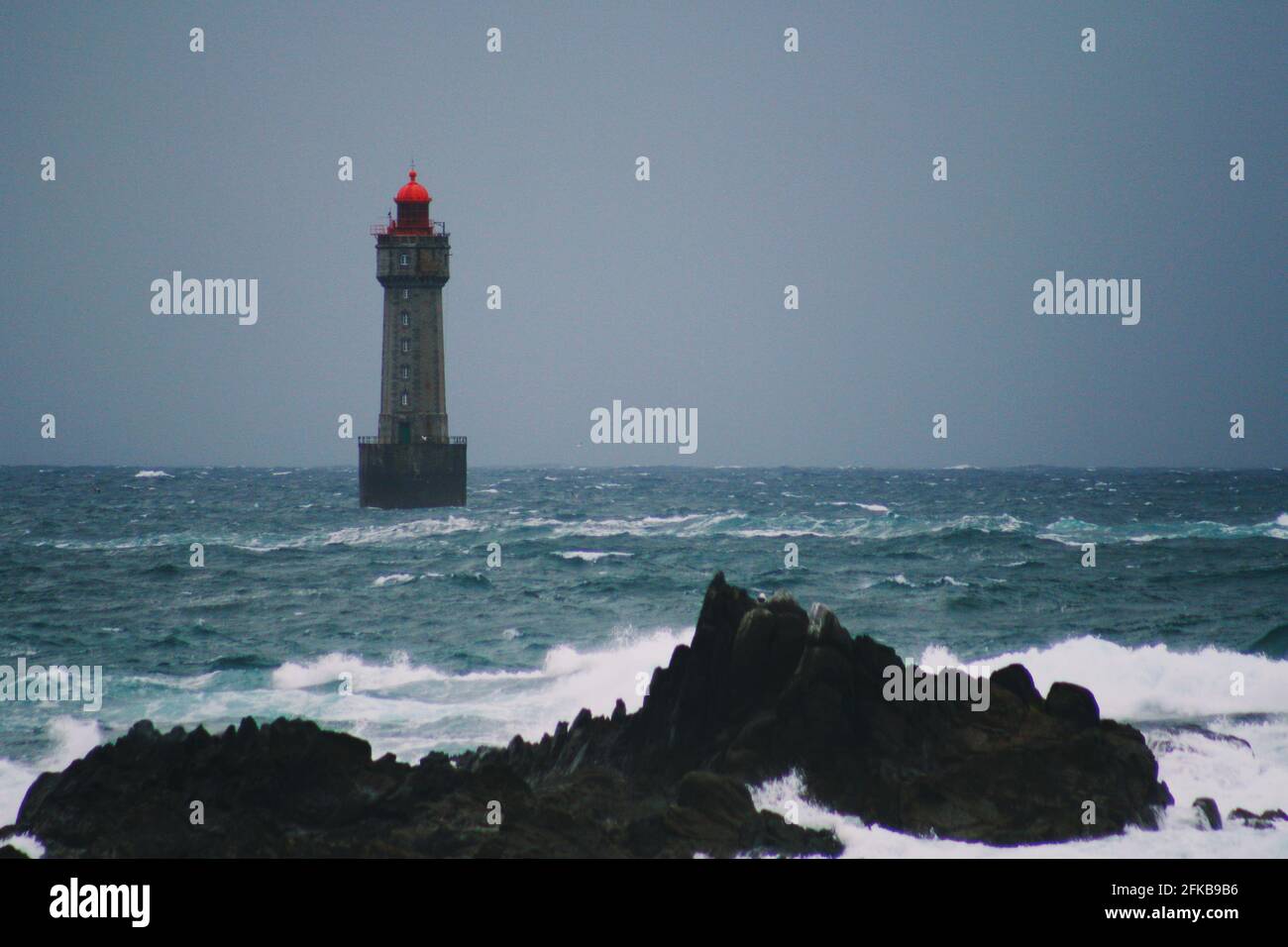 red lighthouse in the ocean. Brittany, France Stock Photo - Alamy