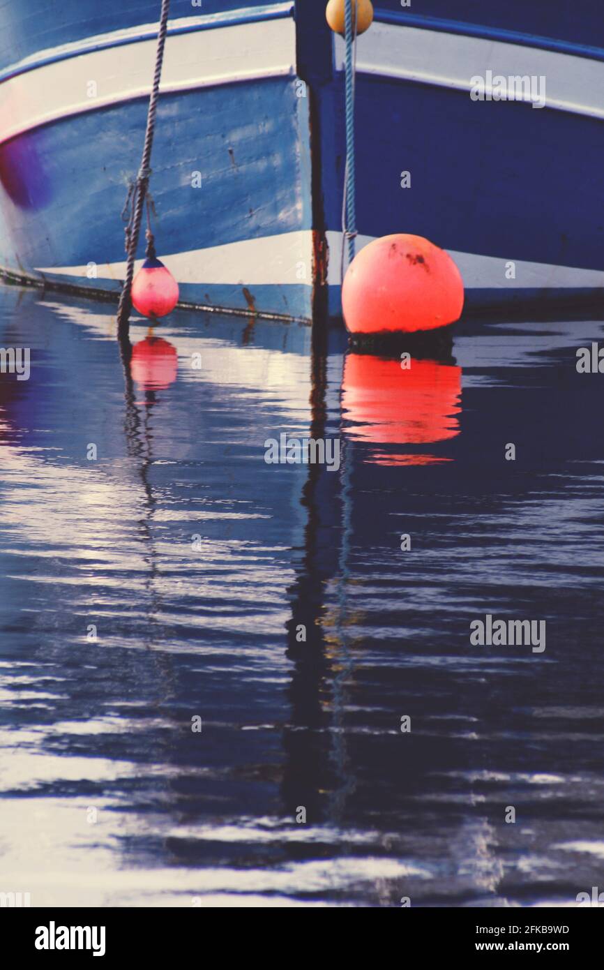 Blue boat with reflection in the water mirror Stock Photo - Alamy