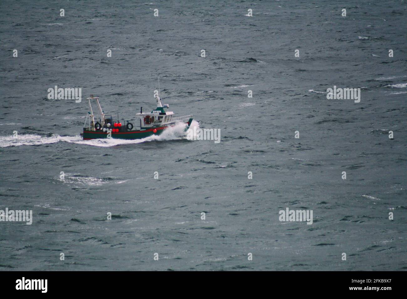 fishing boat in the ocean waves. Brittany, France Stock Photo - Alamy