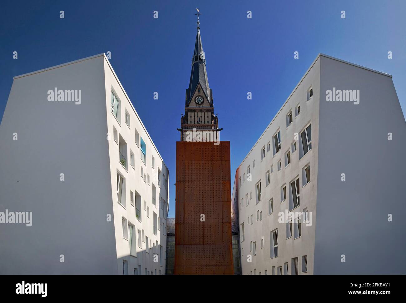 steeple of the Christuskirche behind modern apartment buildings ...