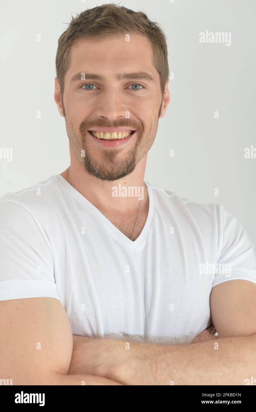Portrait of handsome young man posing in studio Stock Photo - Alamy