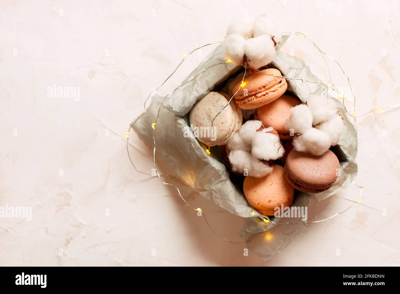 Stylish composition of French macaroons in box, cotton boll & christmas ...