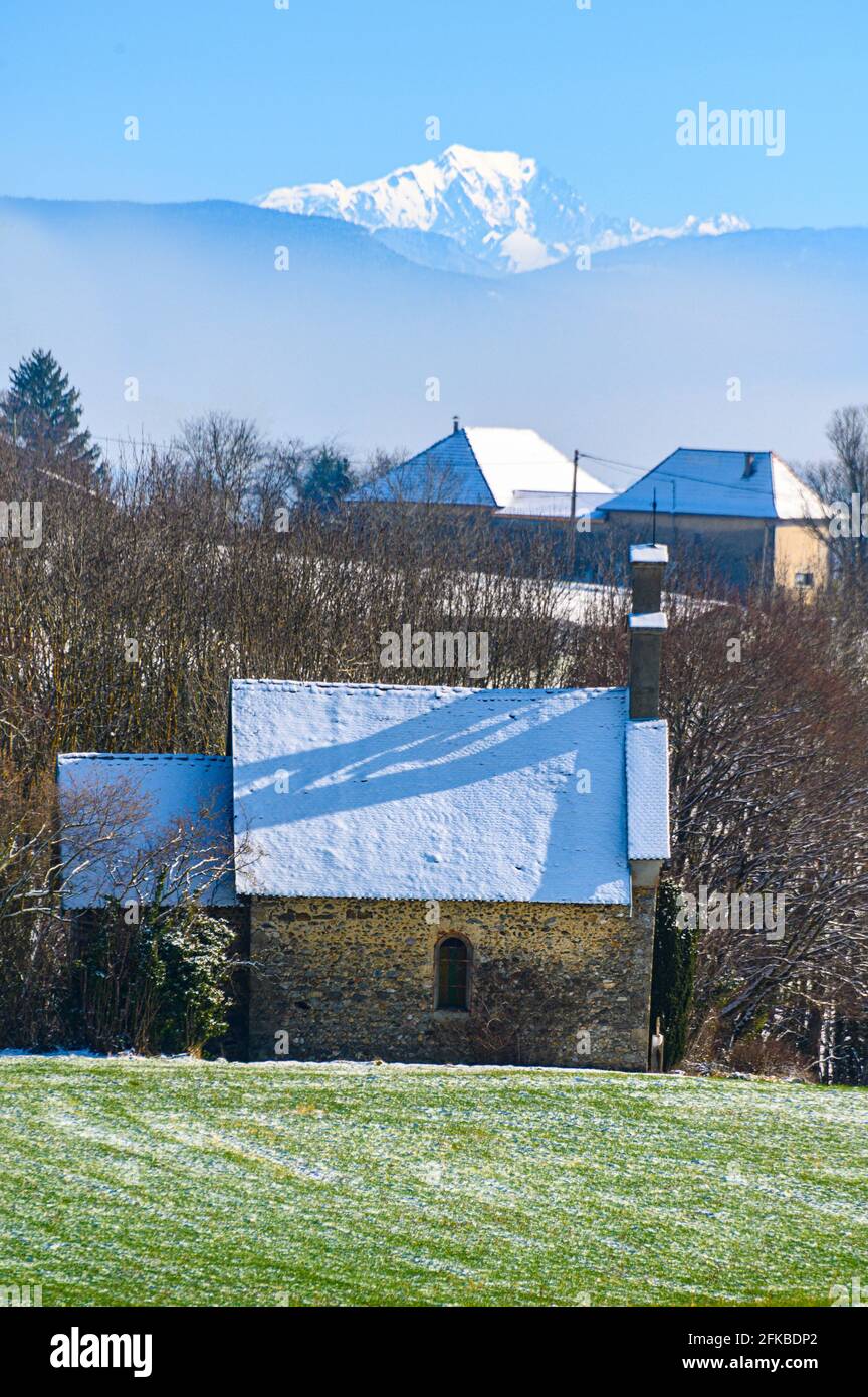 Front view of a small cottage and alps mountain rising in the ...