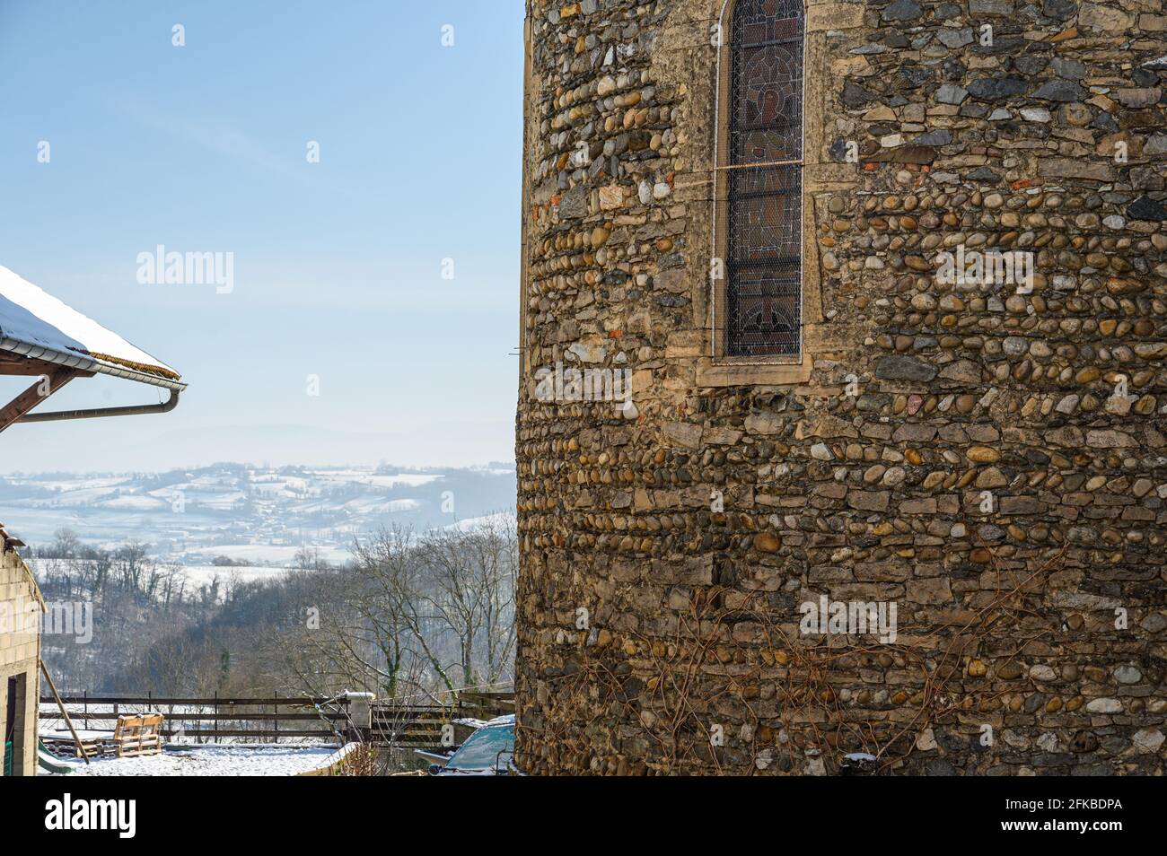 Old building wall made up of round rocks having a metal window Stock ...
