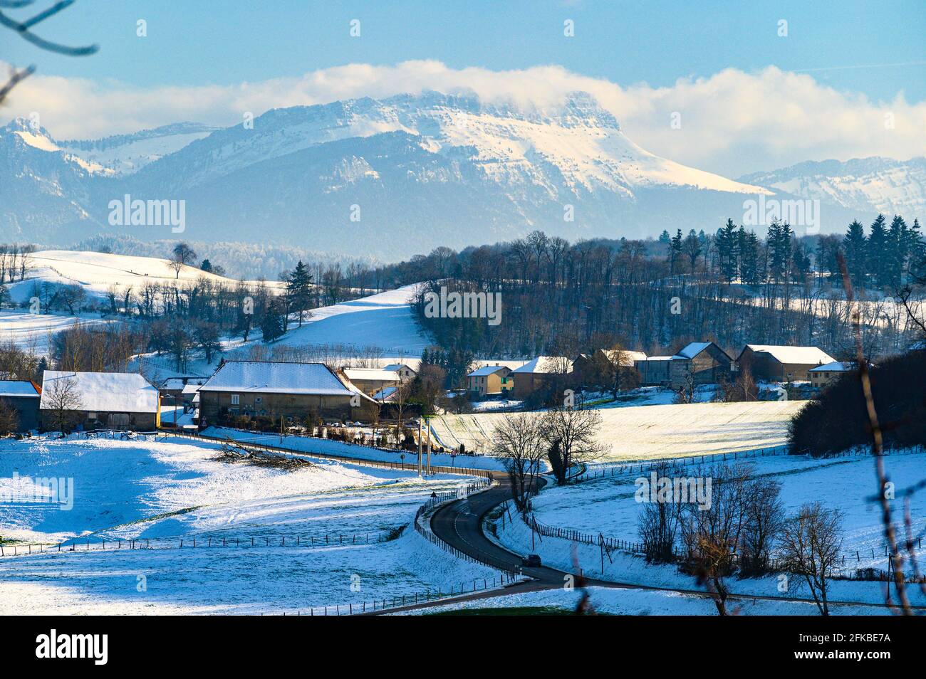 Breathtaking view of Alps Mountain Range behind a small town located at ...