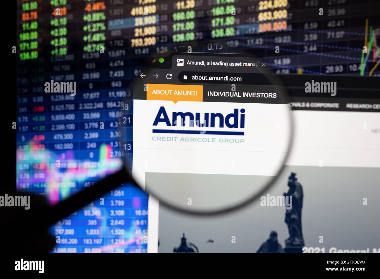 Amundi company logo on a website with blurry stock market developments in the background, seen ...