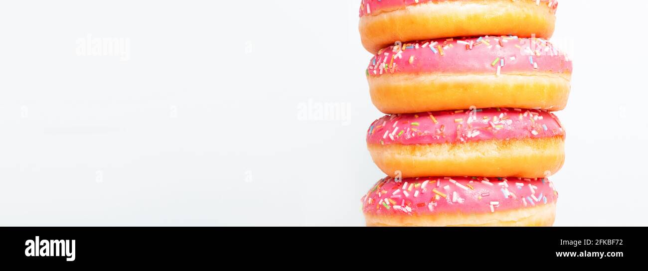 Banner with stack of yummy, fresh, glazed donuts. Close-up. Left copy ...