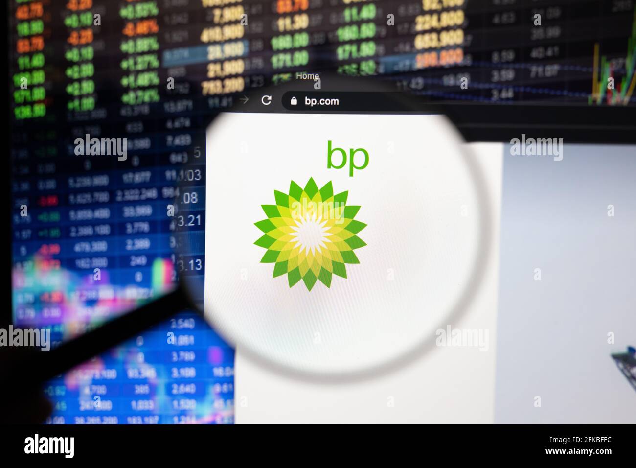 BP company logo on a website with blurry stock market developments in the background, seen on a ...