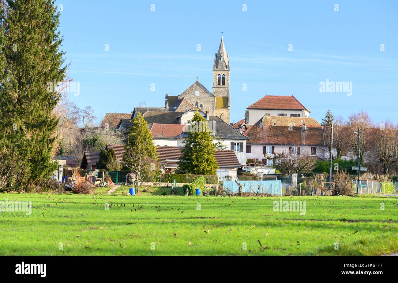 Front low angle shot of small town entrance and a huge church building ...