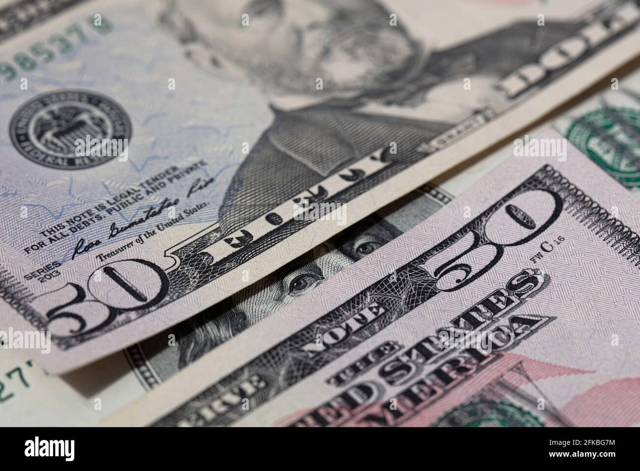 Benjamin Franklin peeking through 50 dollar banknotes for design ...